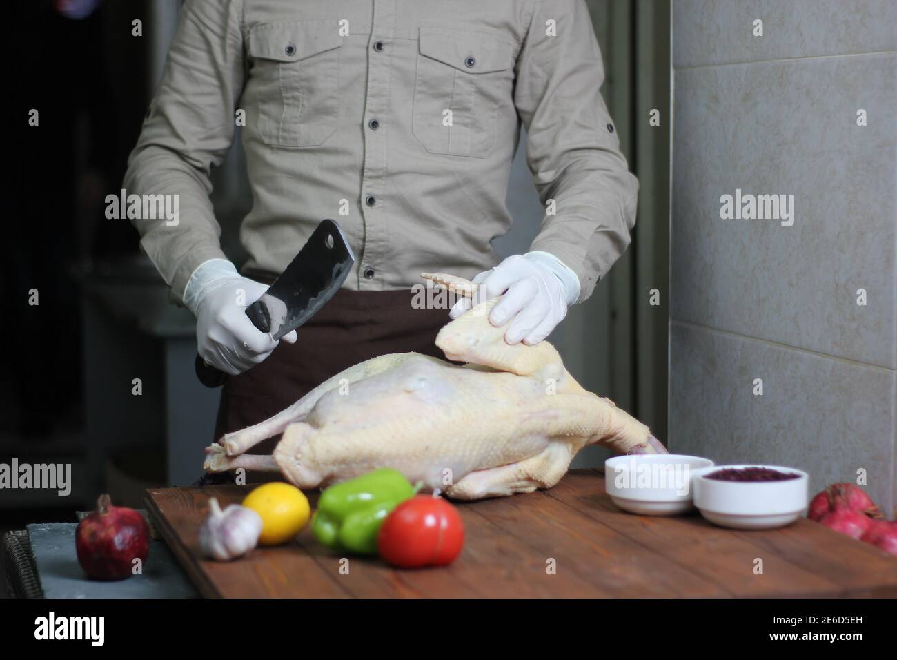 A butcher wrapping a piece of pork meat on a counter Stock Photo - Alamy