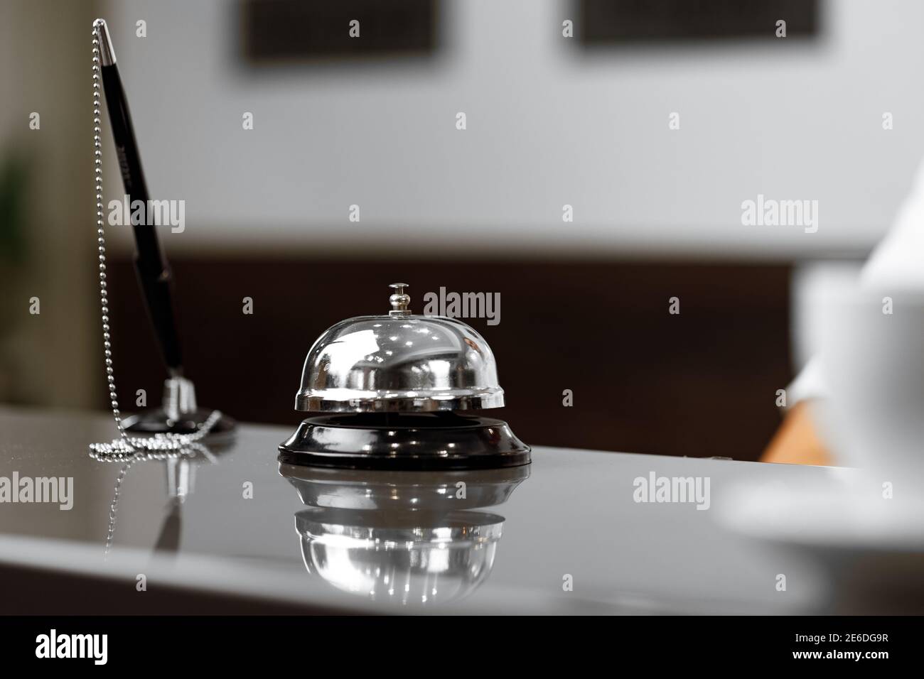 Hotel service bell on front desk counter Stock Photo - Alamy