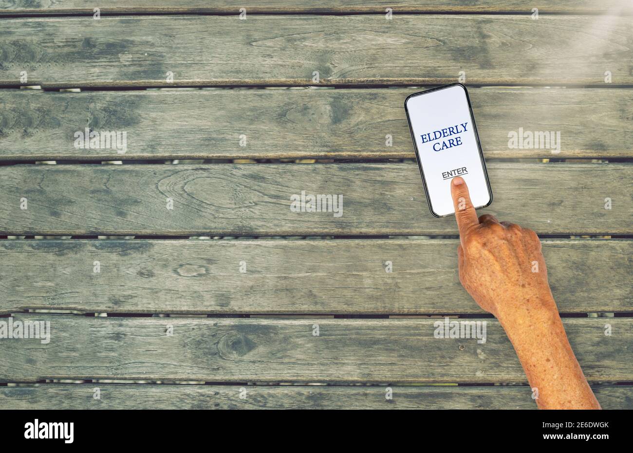 Enter Elderly Care app with senior hand touching the mobile screen on ...