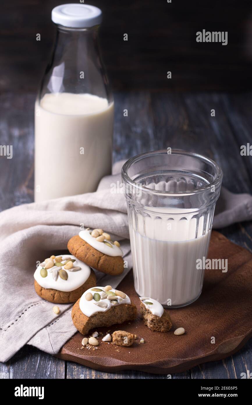 Christmas gingerbread with nuts and seeds with milk on a wooden table ...