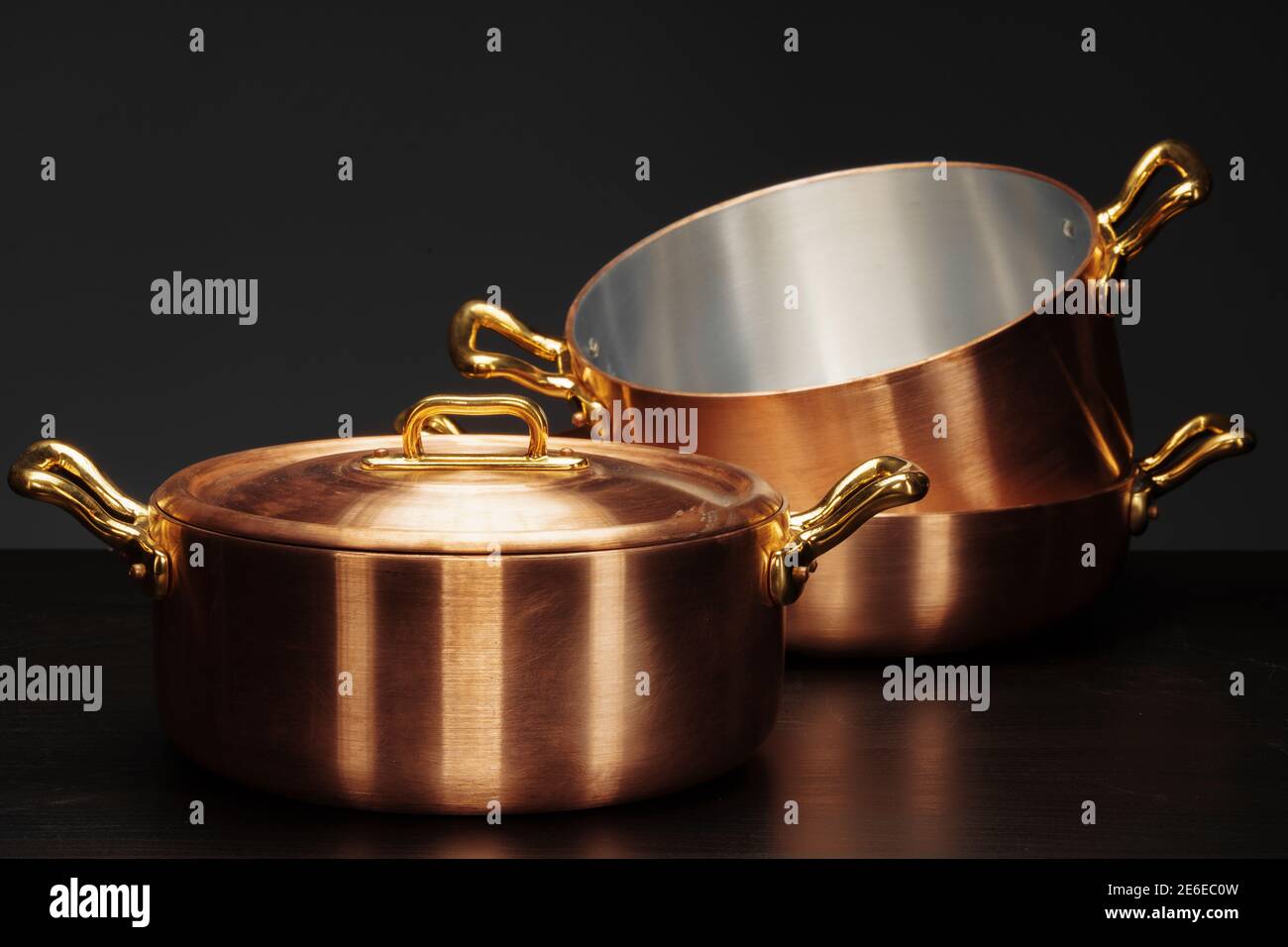 Set of copper cookware over dark background Stock Photo - Alamy