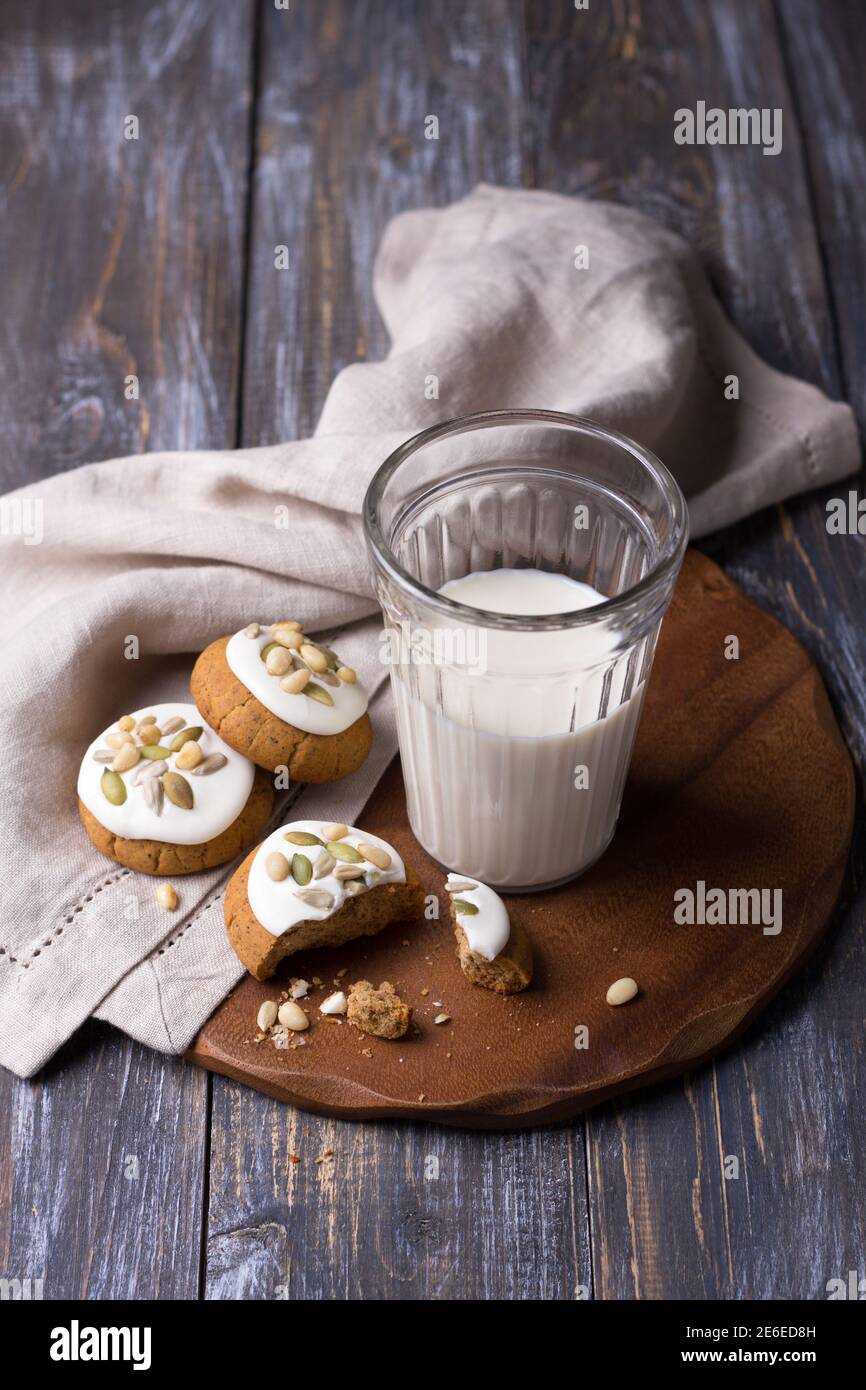 Christmas gingerbread with nuts and seeds with milk on a wooden table ...