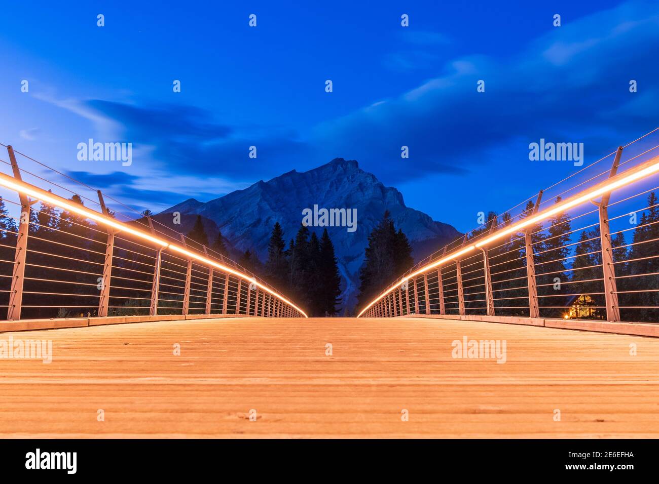 Banff Pedestrian Bridge Bow River trail light up at summer night. Banff ...