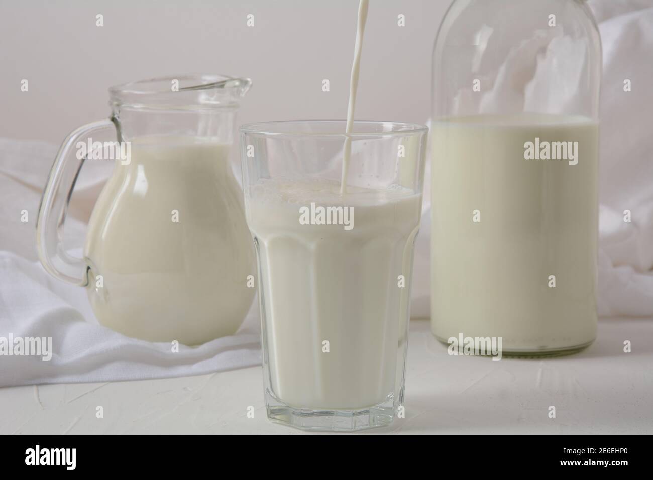 Milk in a glass, jar, and bottle, on white background Stock Photo - Alamy