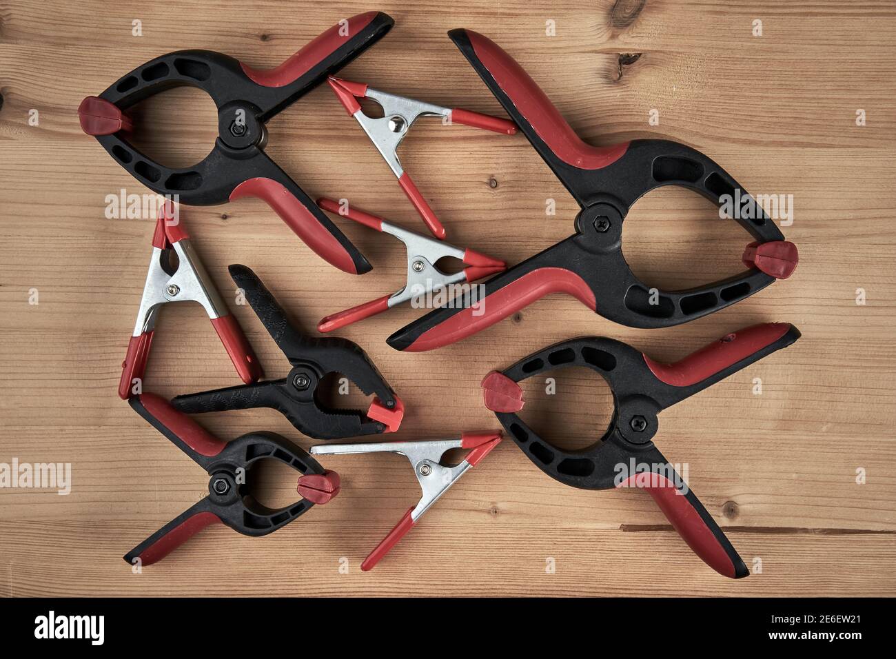 Various clamps on a wooden board, flat lay shot Stock Photo - Alamy
