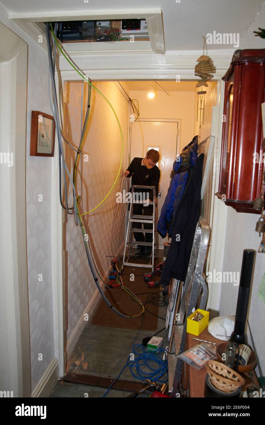 Electrician refitting and testing a new fuse board and safety checking ...