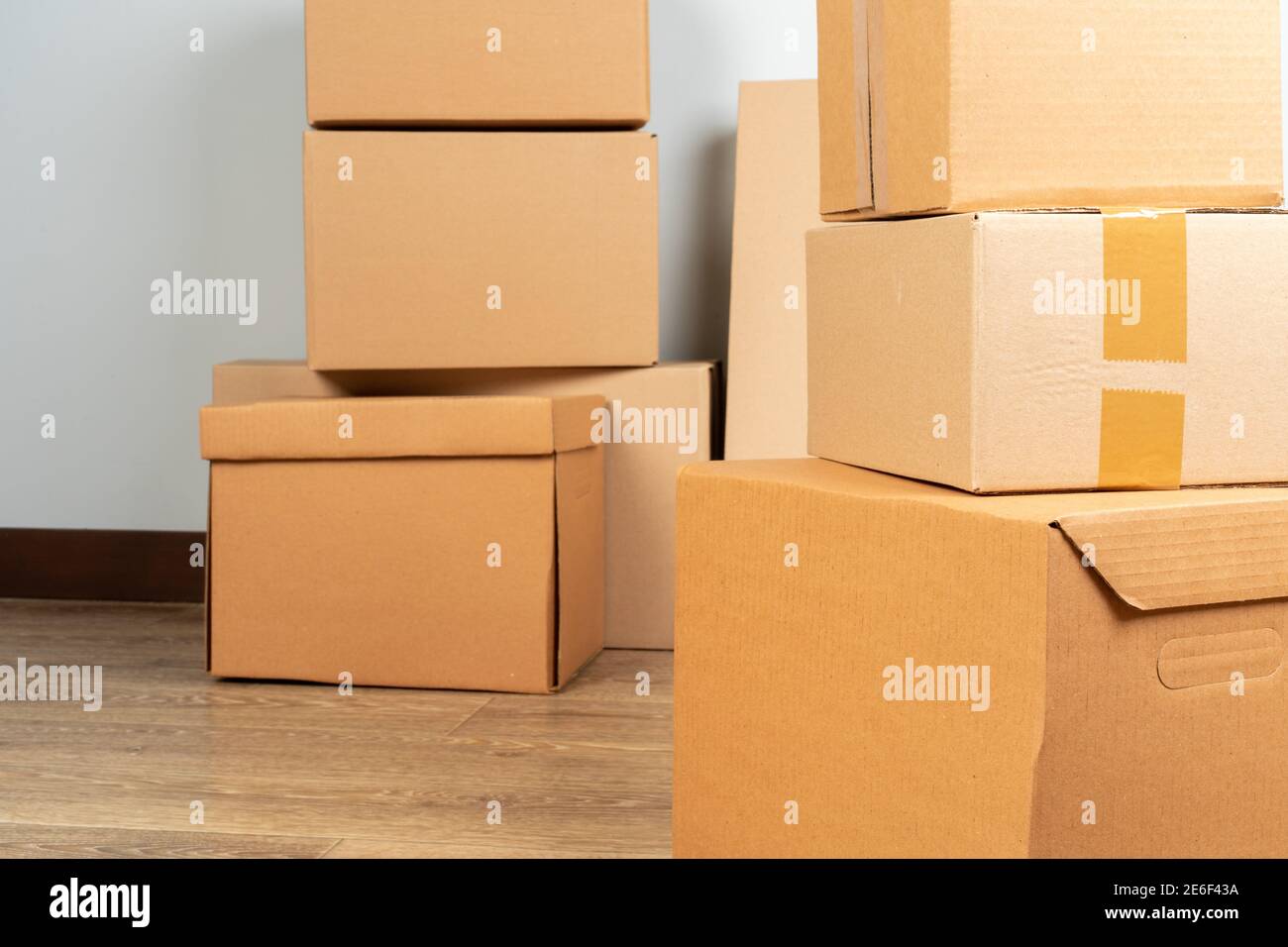 Group of brown carton boxes on wooden floor Stock Photo - Alamy