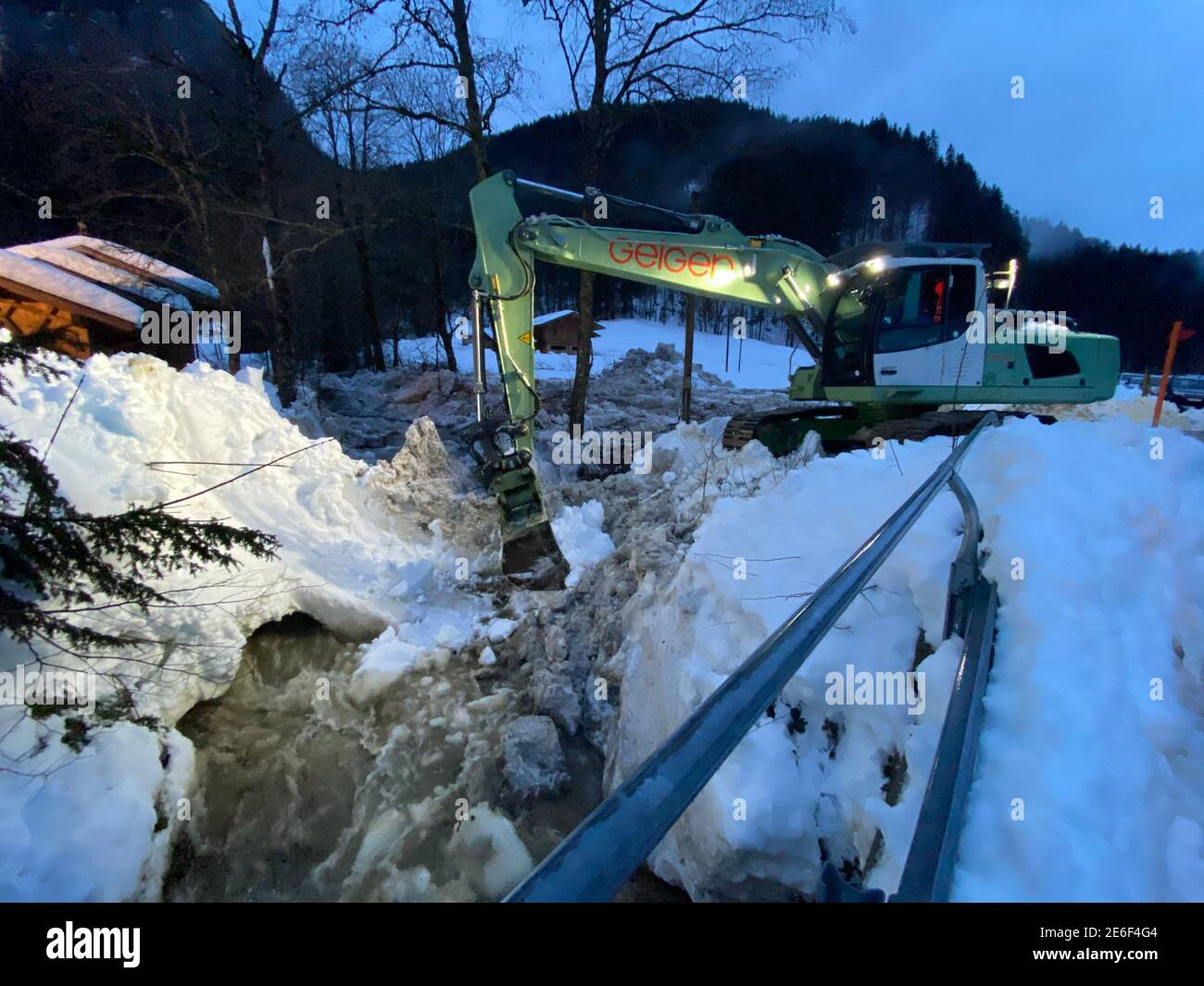 Obermaiselstein, Germany. 29th Jan, 2021. An excavator shovels a stream ...