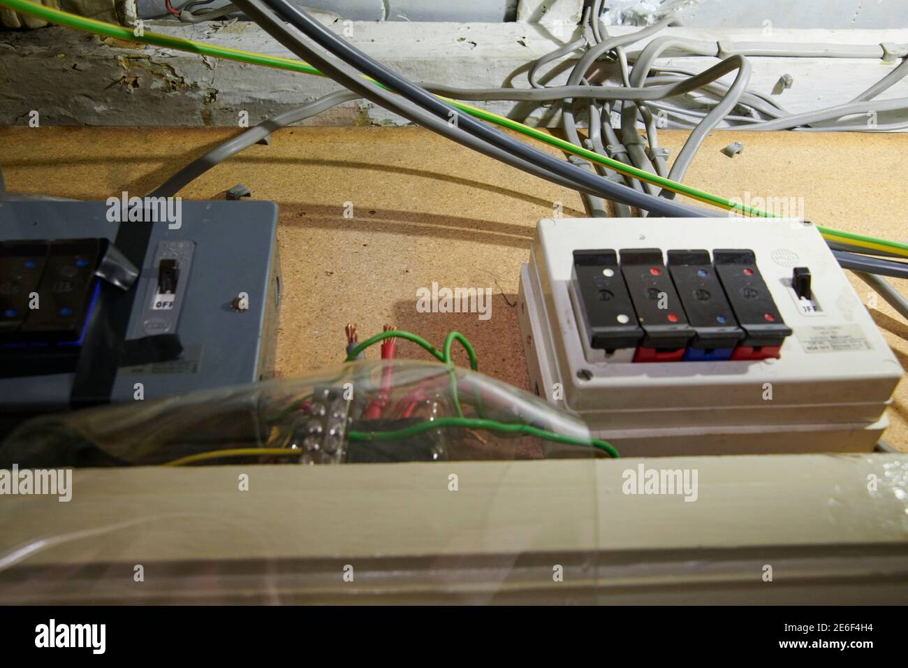 Electrician refitting and testing a new fuse board and safety checking ...