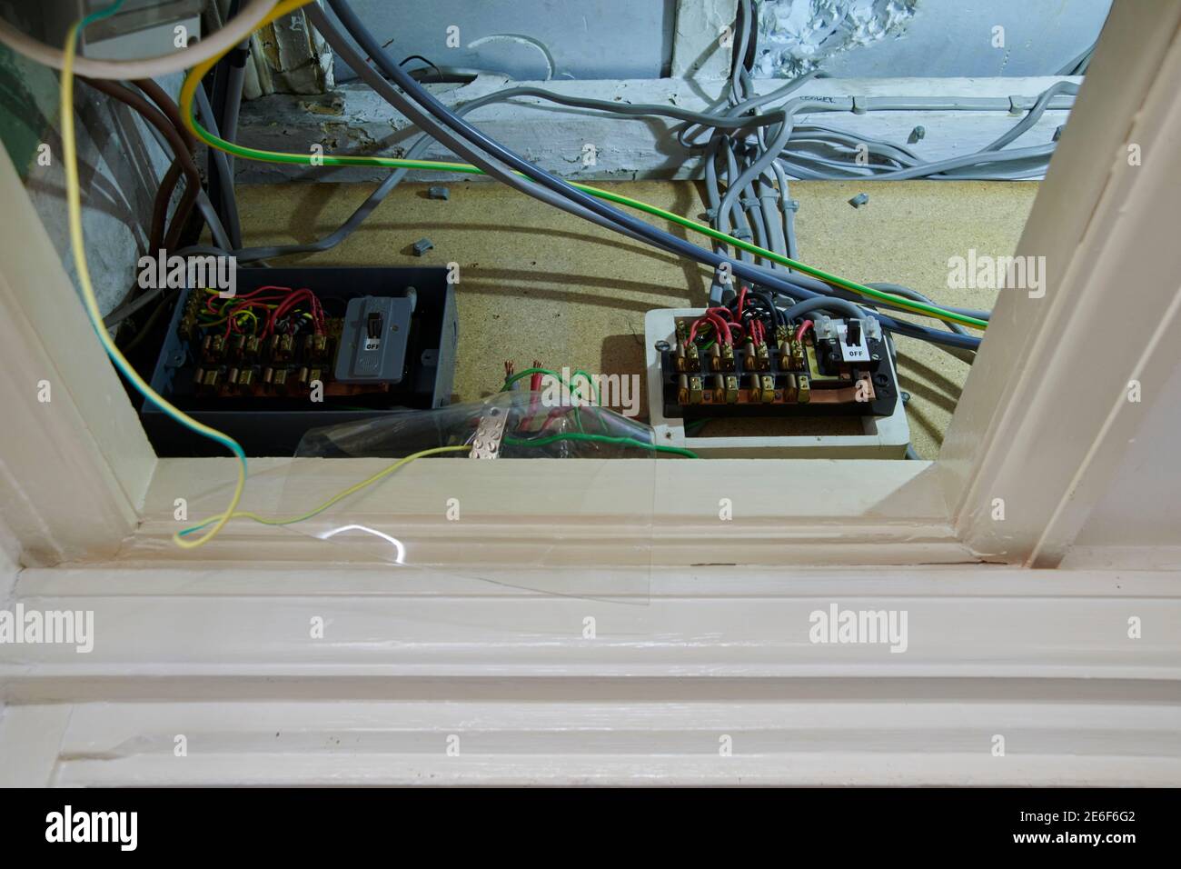 Electrician refitting and testing a new fuse board and safety checking ...
