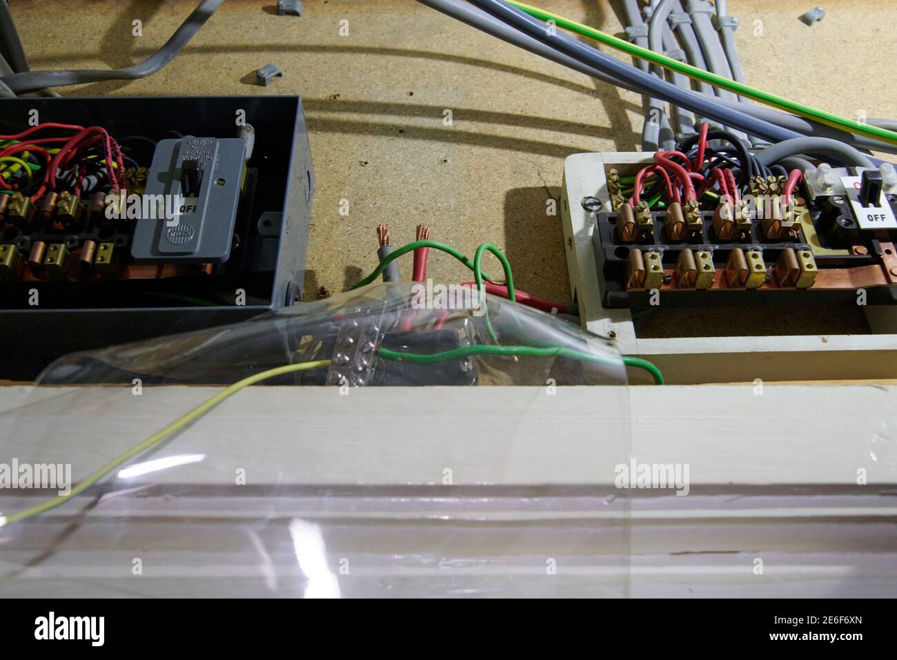 Electrician refitting and testing a new fuse board and safety checking ...