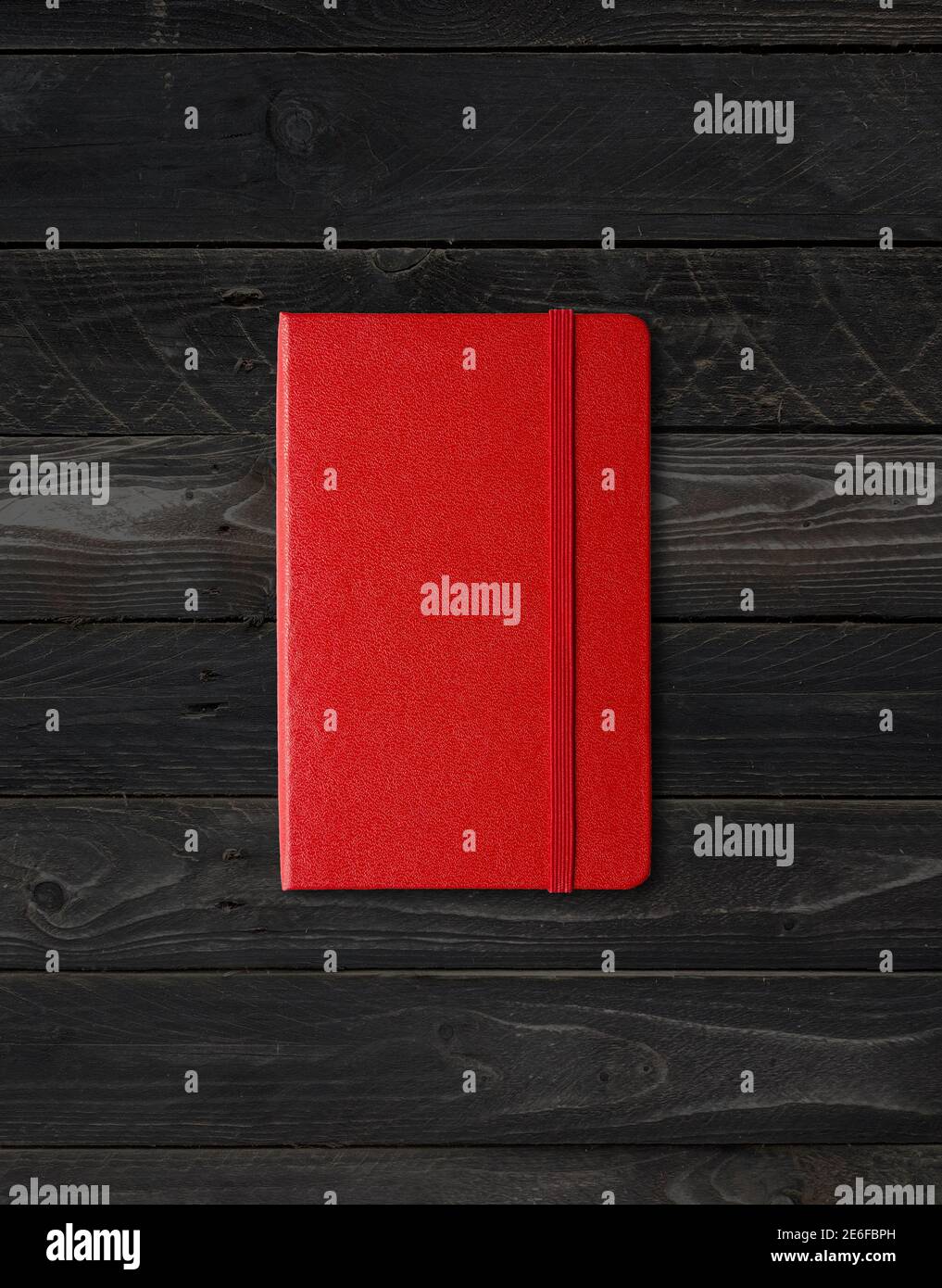 Red closed notebook mockup isolated on black wood background Stock ...