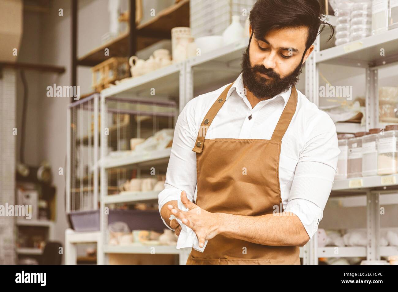Portrait of a young businessman craftsman with a beard and mustache in ...