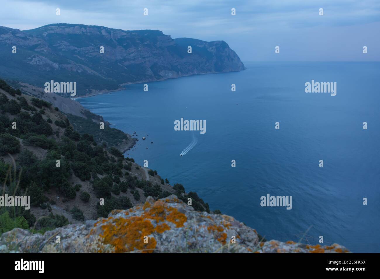 A lonely boat in the endless blue sea. Top view of the sea on the ...