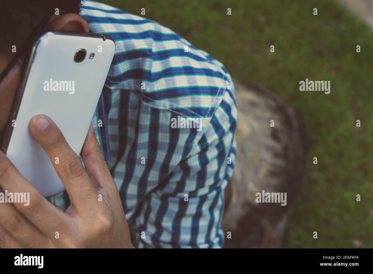 Close up man using mobile smart phone green background Stock Photo - Alamy