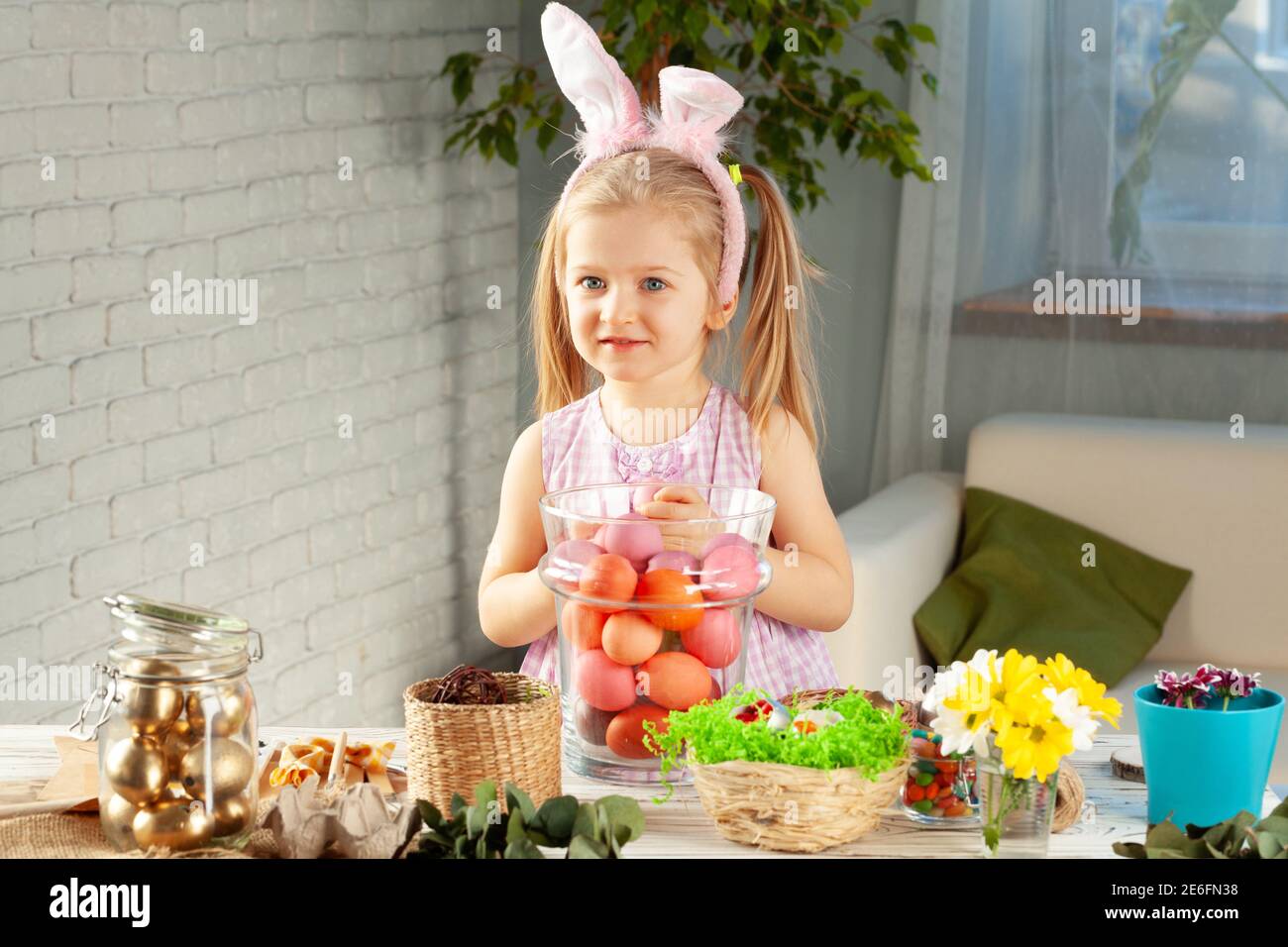 Happy little girl with bunny ears getting ready for Easter party Stock ...