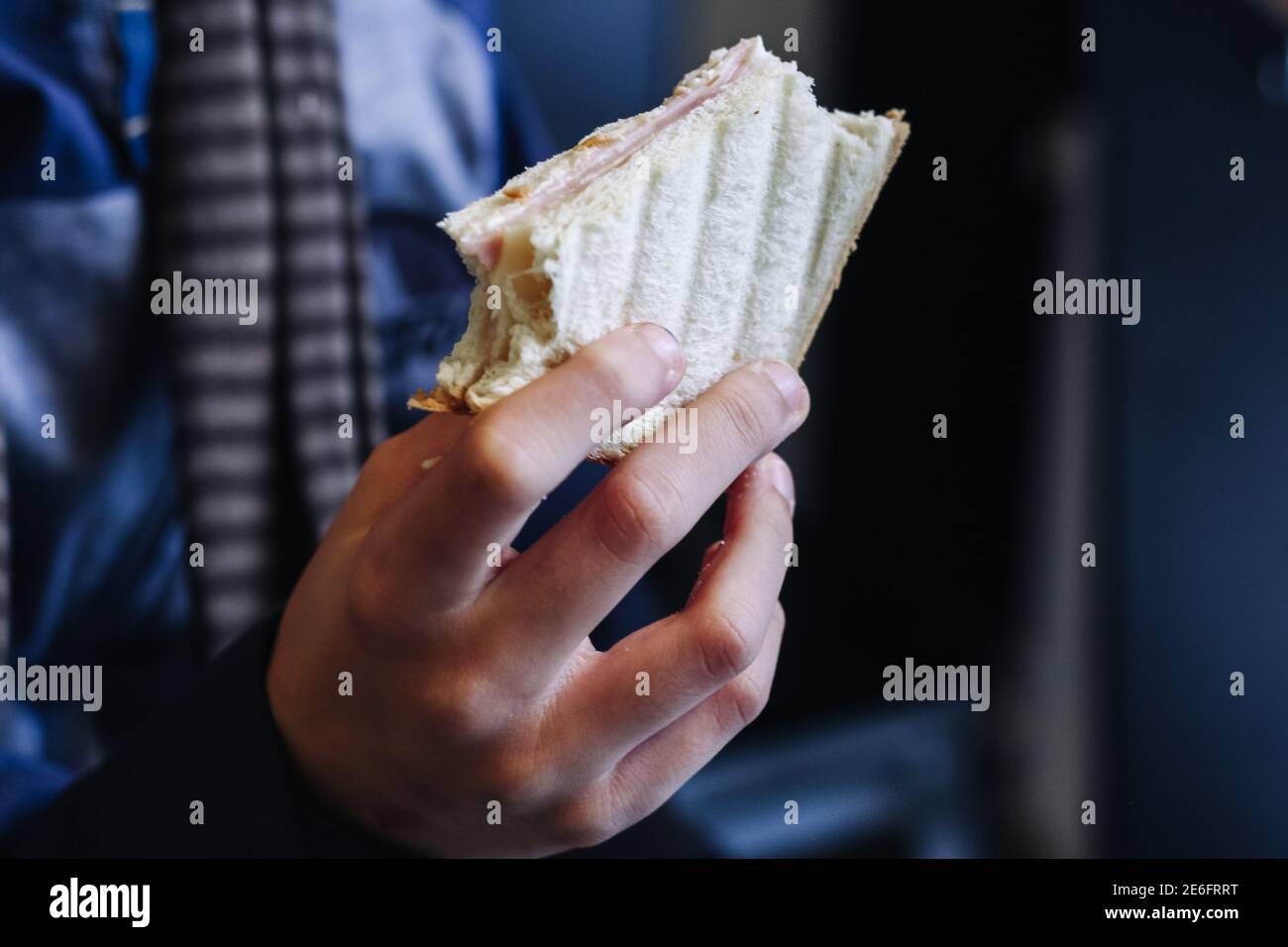 Bitten Sandwich with Ham in the Boy's Hand Stock Photo - Alamy