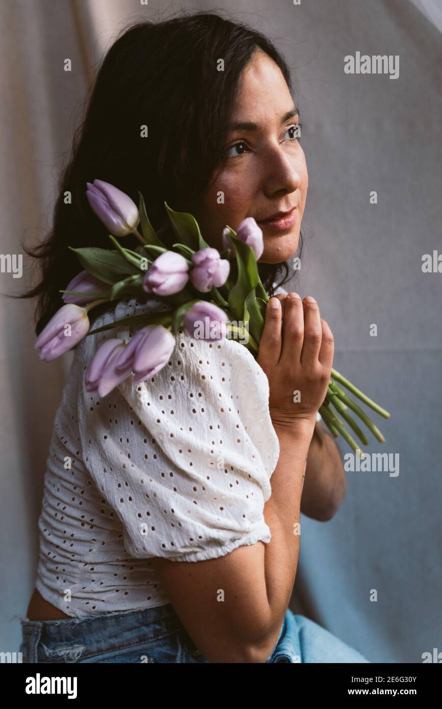 authentic portrait of young woman in casual clothes holding purple ...