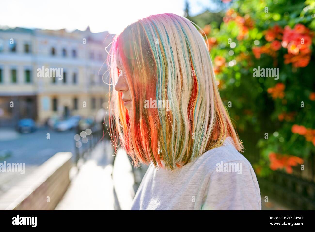 Close-up of teenager girl's head with multi-colored dyed hair, complex ...