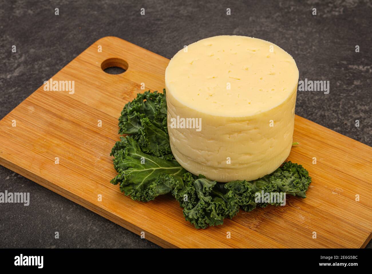 Yellow round dairy soft cheese piece Stock Photo - Alamy