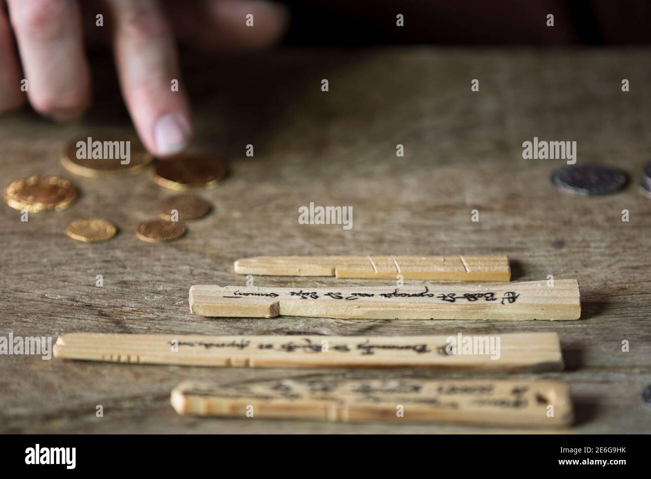 Medieval merchant counting money using tally sticks Stock Photo - Alamy