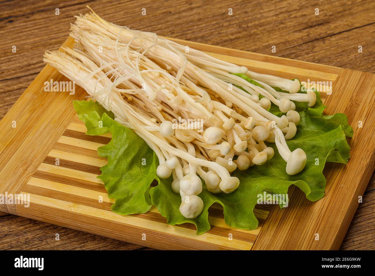 Raw Japanese Enoki mushrooms for cooking Stock Photo - Alamy