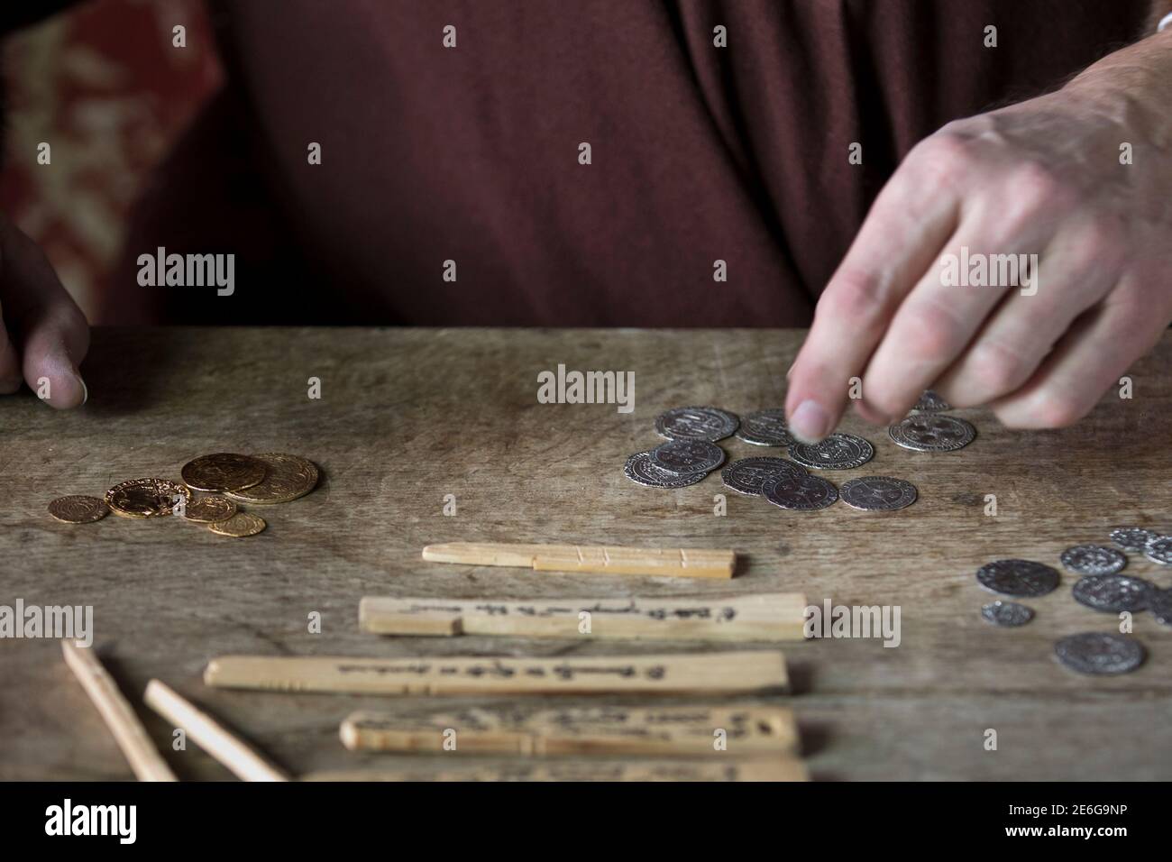 Medieval merchant counting money using tally sticks Stock Photo - Alamy
