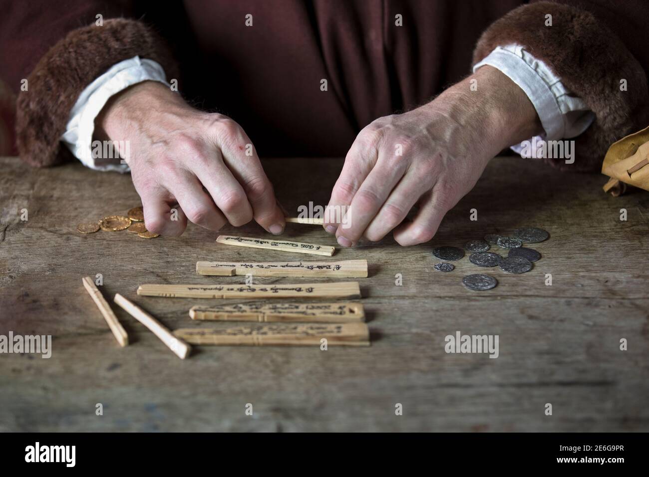 Medieval merchant counting money using tally sticks Stock Photo - Alamy