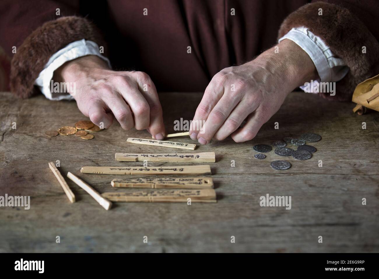 Medieval merchant counting money using tally sticks Stock Photo - Alamy