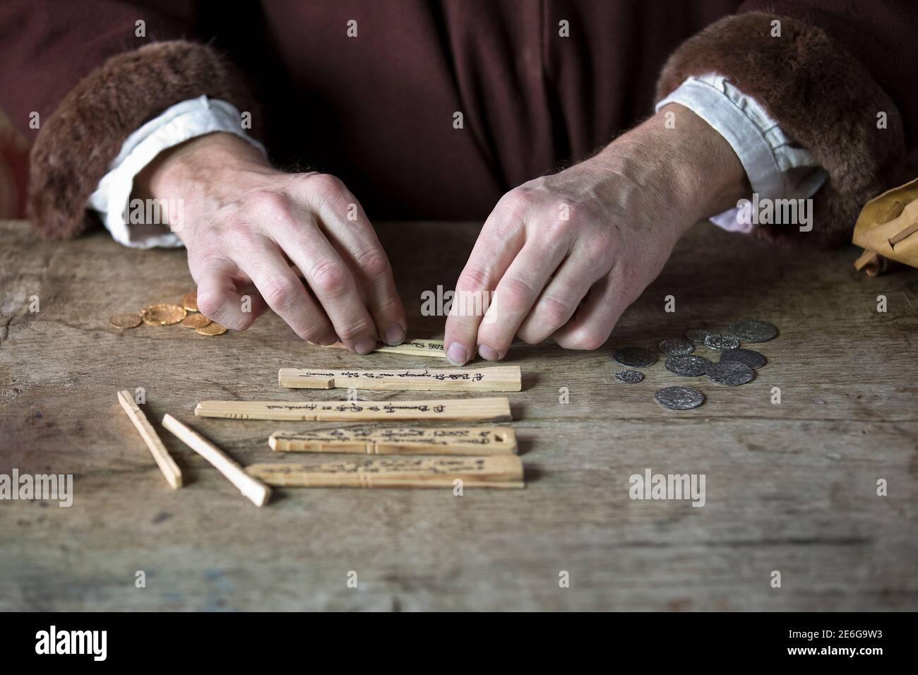 Medieval merchant counting money using tally sticks Stock Photo - Alamy