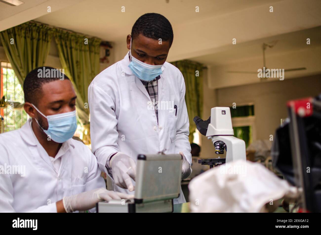 Young black scientists carrying out some experiments in the laboratory ...