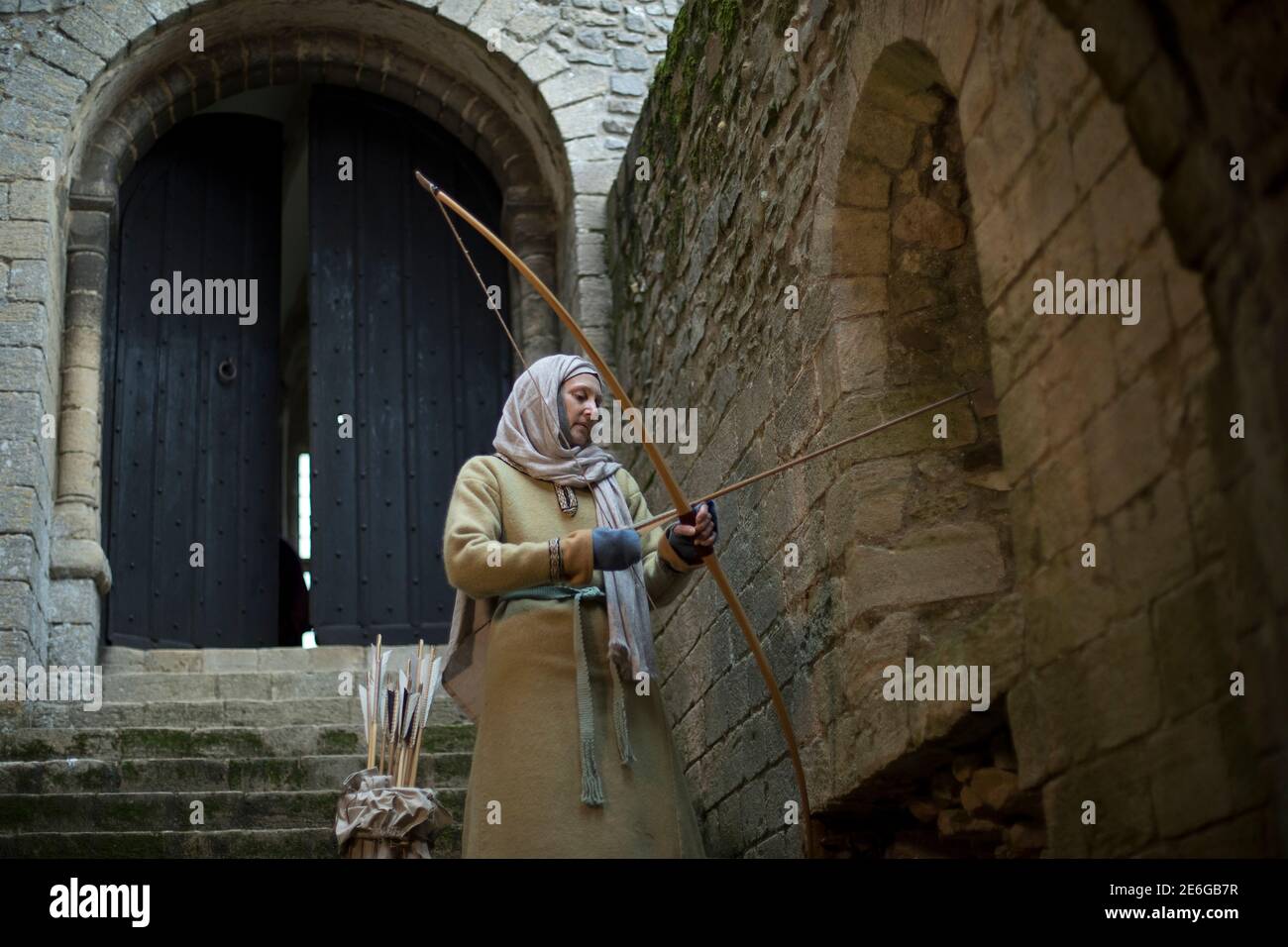 Medieval female archer defending castle keep Stock Photo - Alamy