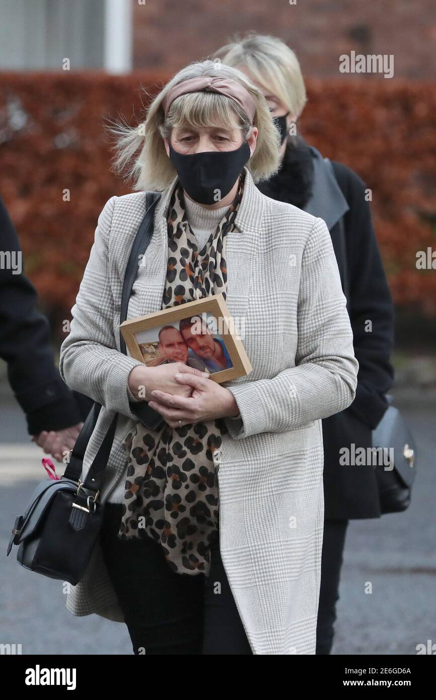 Victim Simon Midgley's mother, Jane Midgley, carries a photograph of ...