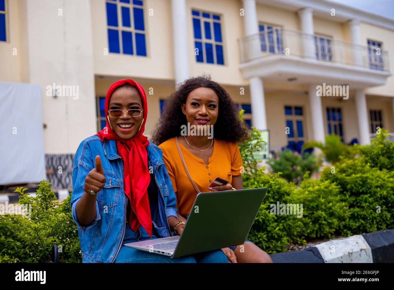 young black beautiful ladies sitting out and working on her laptop ...