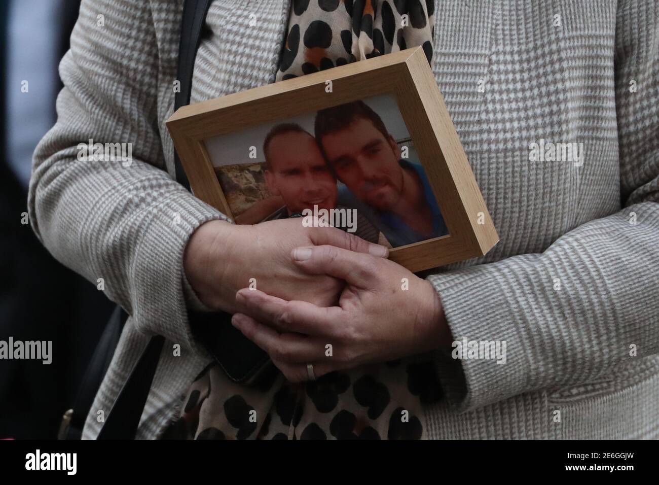 Victim Simon Midgley's mother, Jane Midgley, carries a photograph of ...