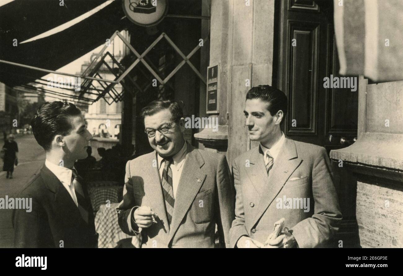 Three men talking in the street, Italy 1940 Stock Photo - Alamy