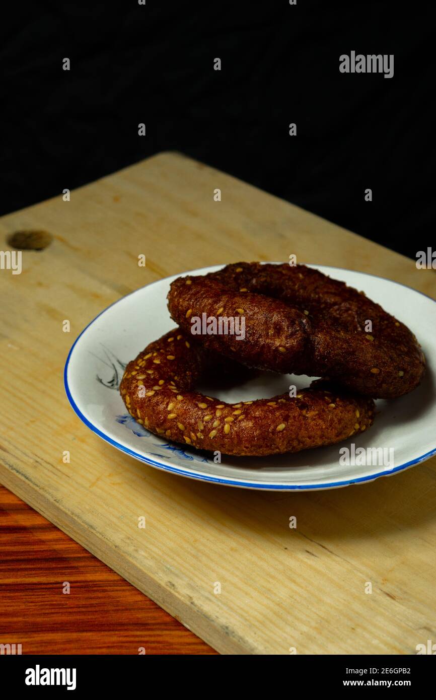 Tasty homemade kajjaya in a white plate kept on a light background ...