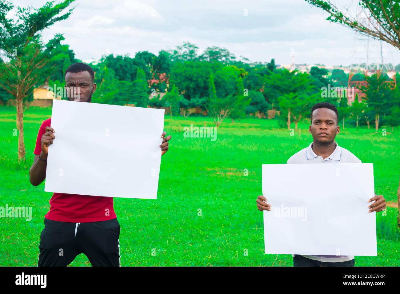 young black men carrying white placards and protesting for their rights ...