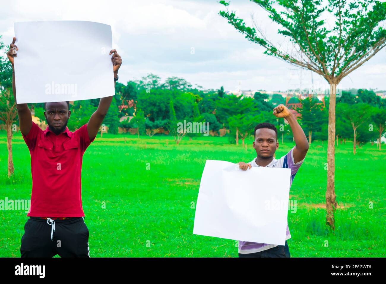 young black men carrying white placards and protesting for their rights ...