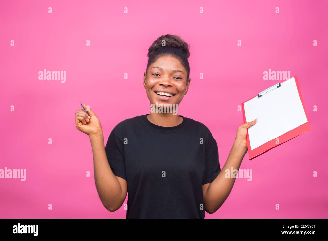 young beautiful black lady holding her notepad with a beautiful smile ...