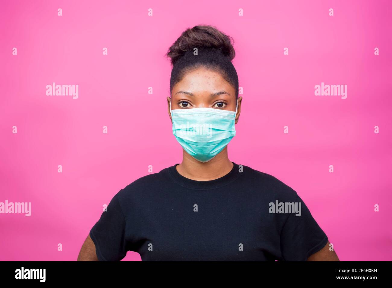 young beautiful black lady wearing a nose mask standing Stock Photo - Alamy