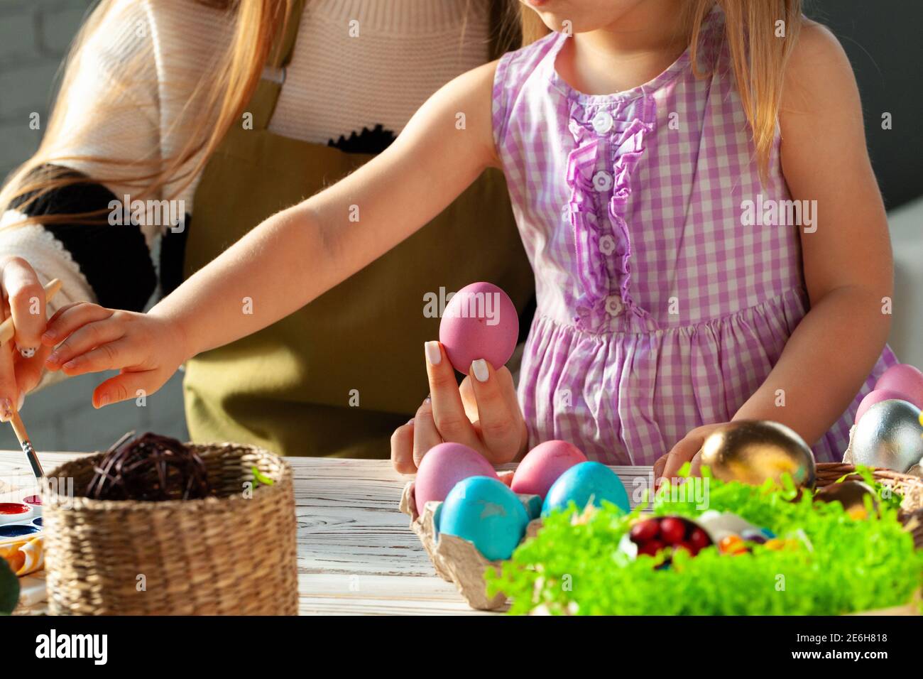 Mother and daughter coloring eggs for Easter Stock Photo - Alamy