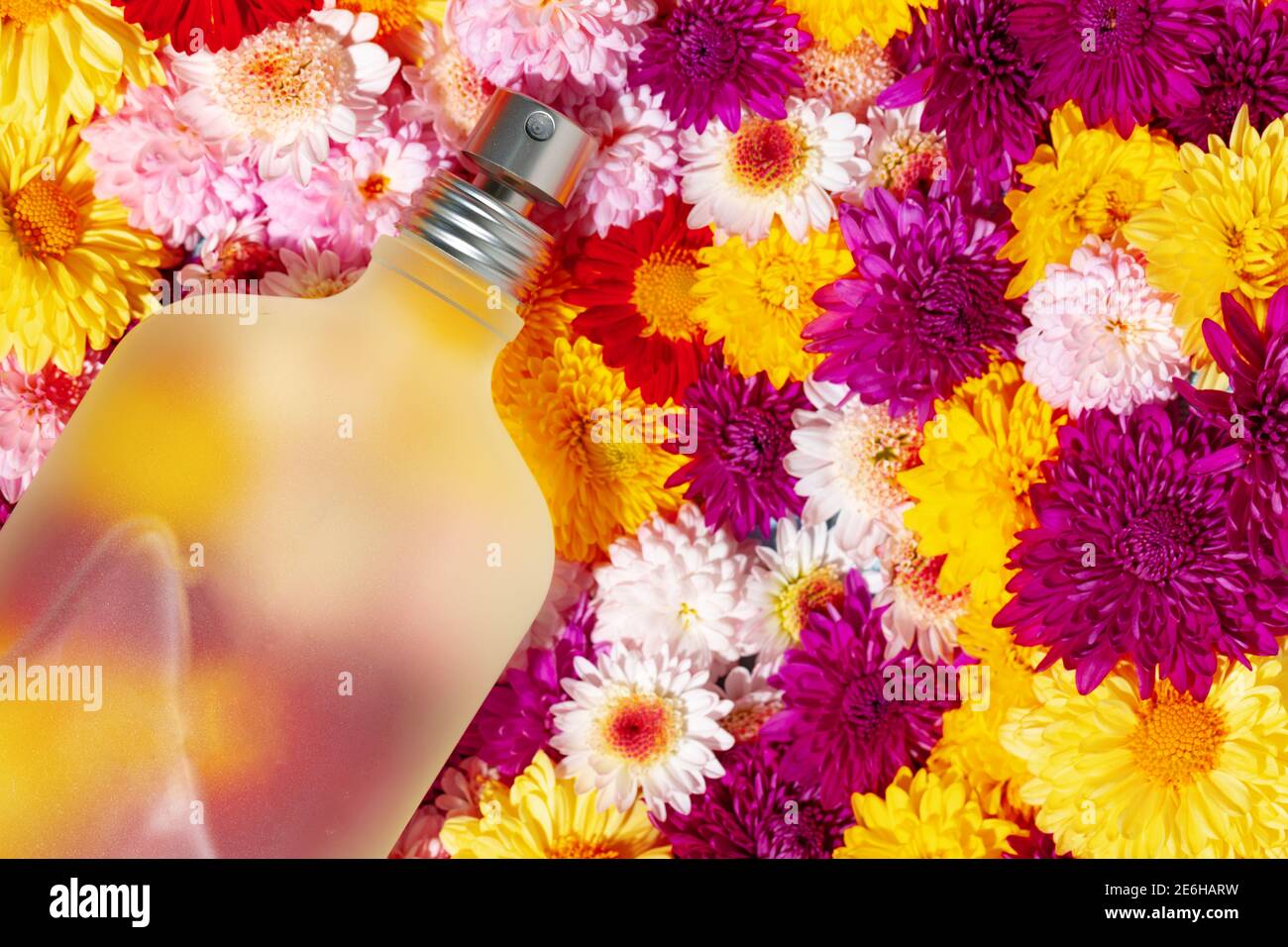 Bottle of fragrance surrounded by flower buds Stock Photo - Alamy