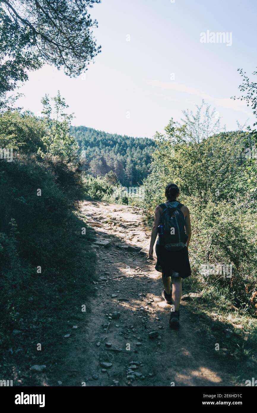 woman walking along a small path in the mountain Stock Photo - Alamy