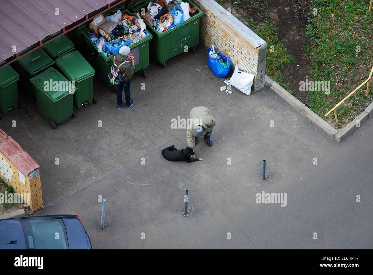 Homeless man looking garbage dumpster hi-res stock photography and ...