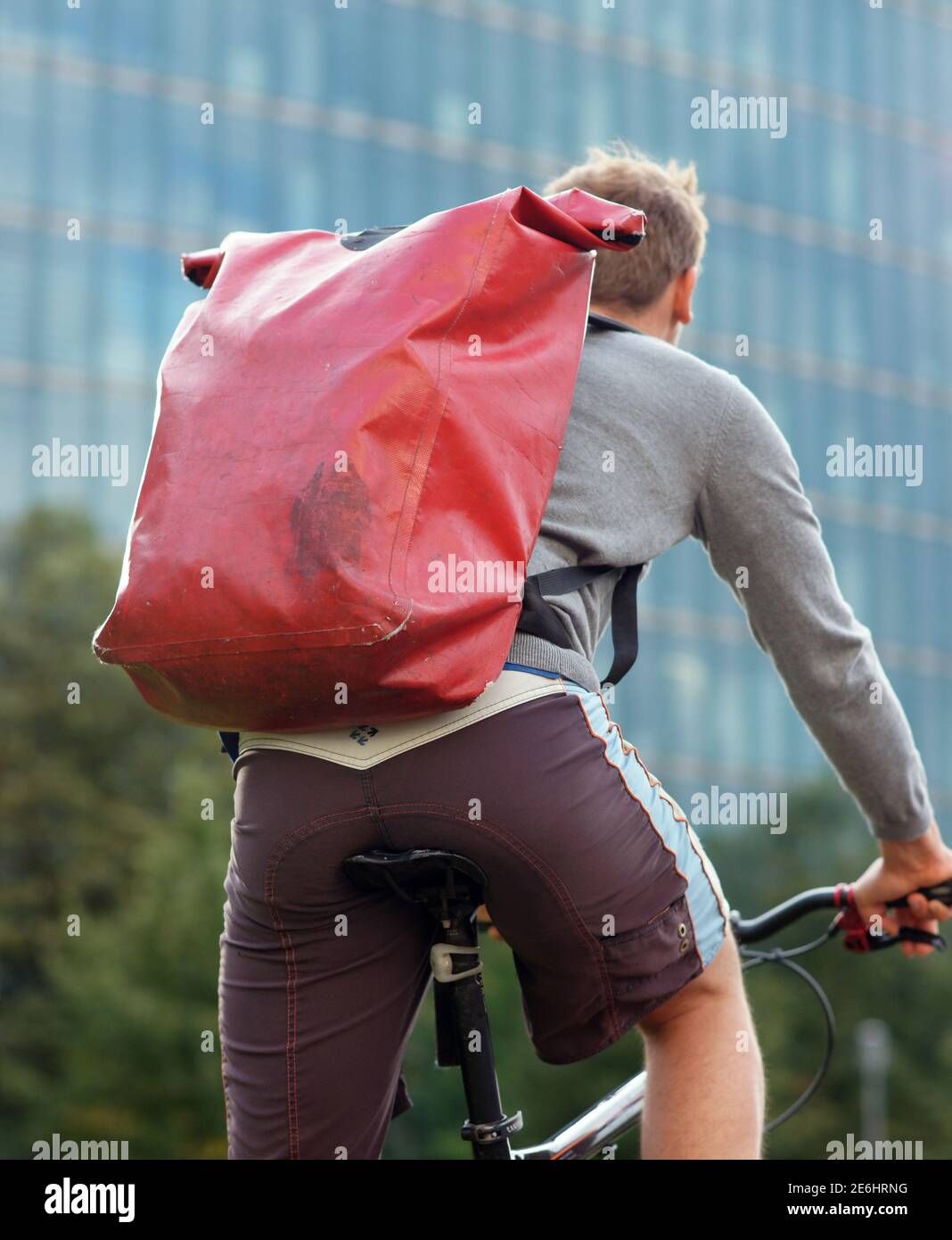 Bicycle messenger in Berlin delivering an envelope Stock Photo - Alamy