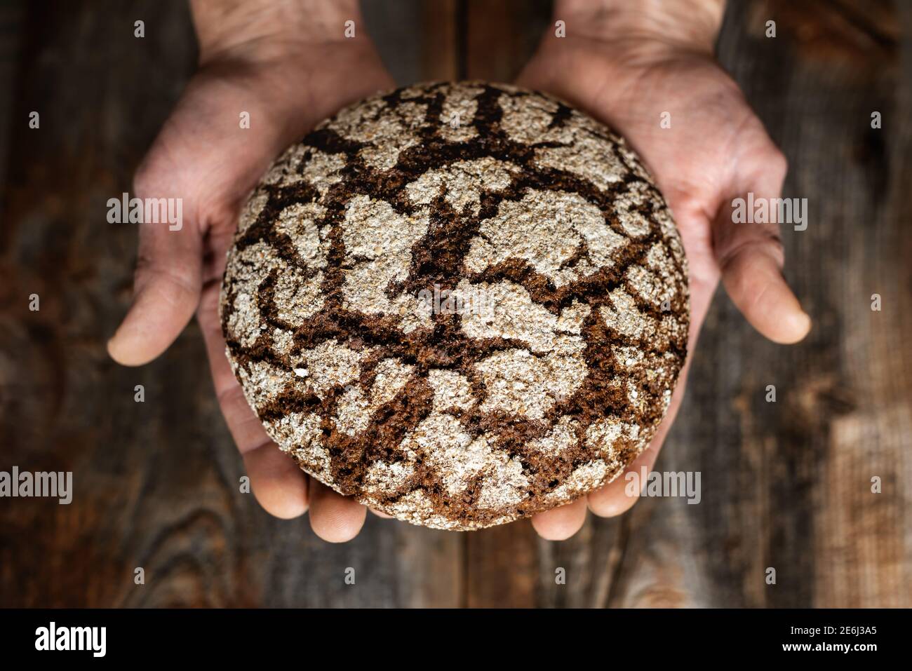 Hands holding loaf bread in hi-res stock photography and images - Alamy