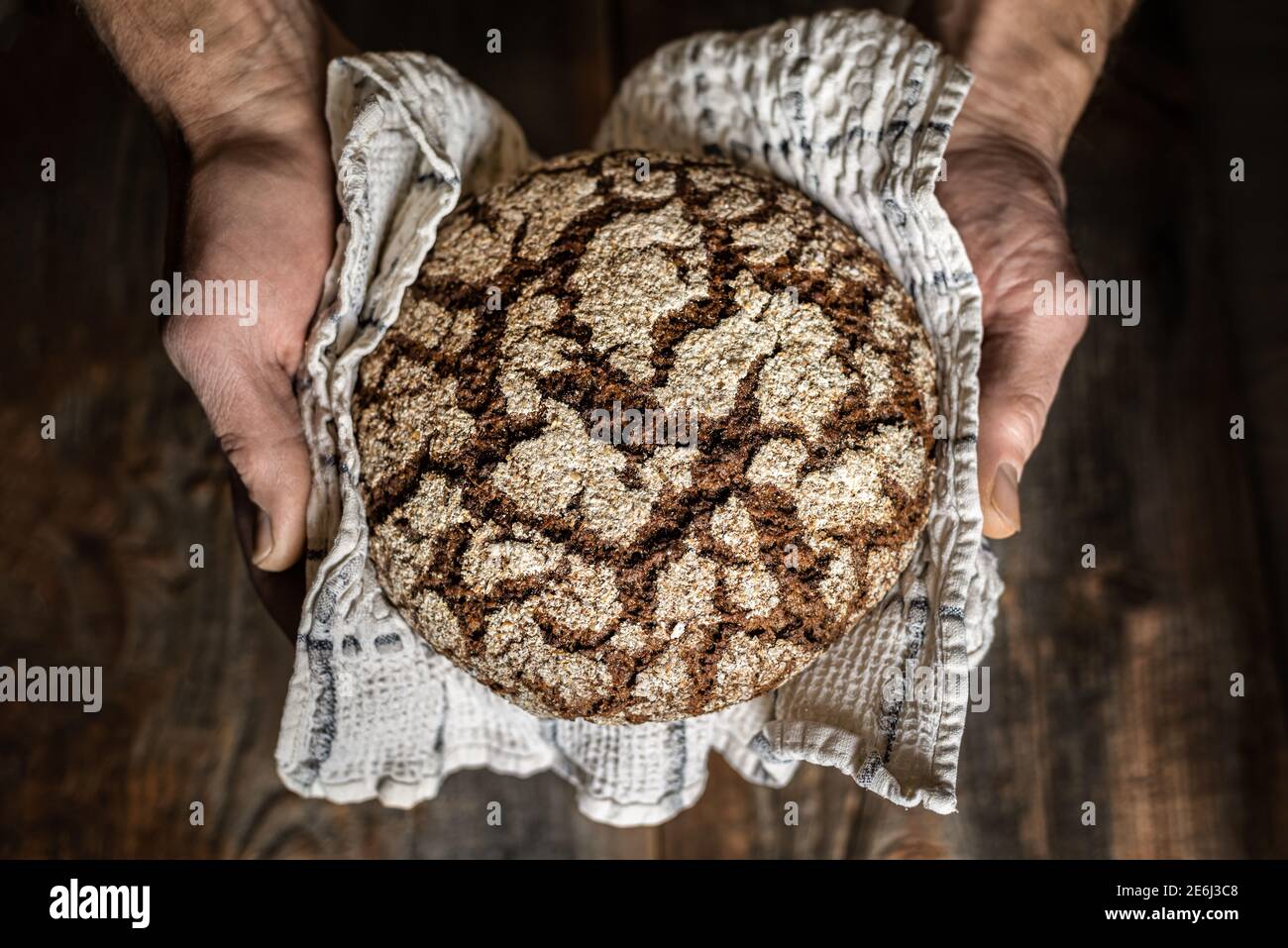Hands holding loaf bread in hi-res stock photography and images - Alamy