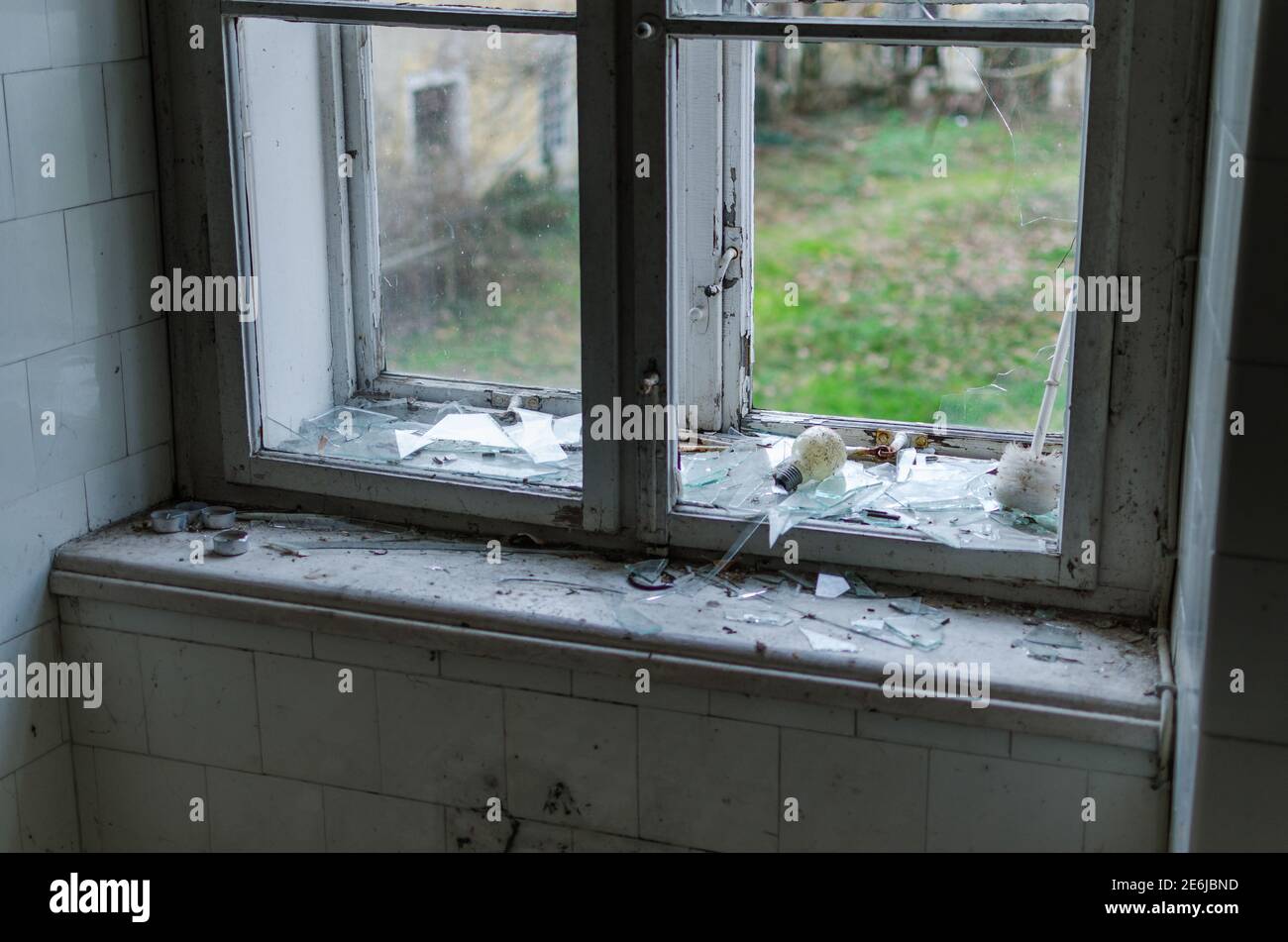 old broken window with a light bulb Stock Photo - Alamy