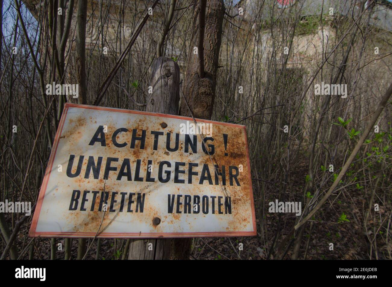 sign with caution risk of accidents at a castle ruin Stock Photo - Alamy